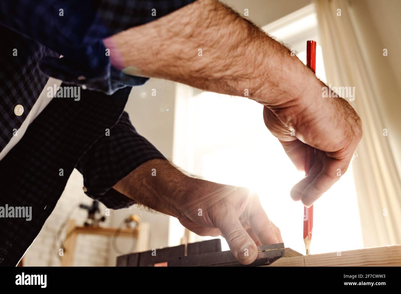 Carpenter makes pencil marks on a wood plank Stock Photo - Alamy