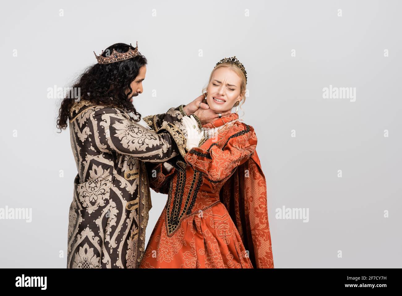 hispanic king in medieval clothing choking queen in crown on white ...