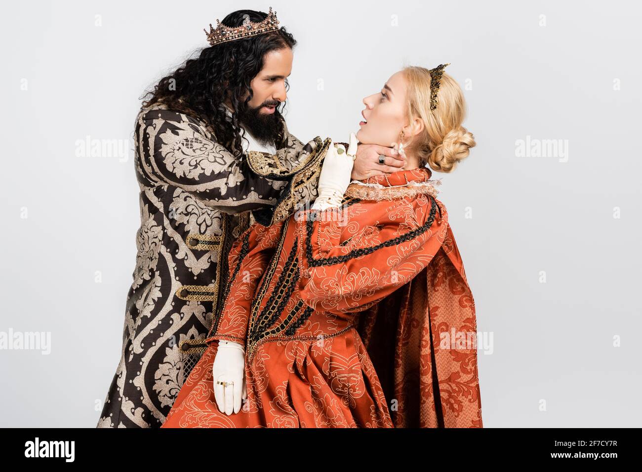cruel hispanic king in medieval clothing choking shocked queen in ...