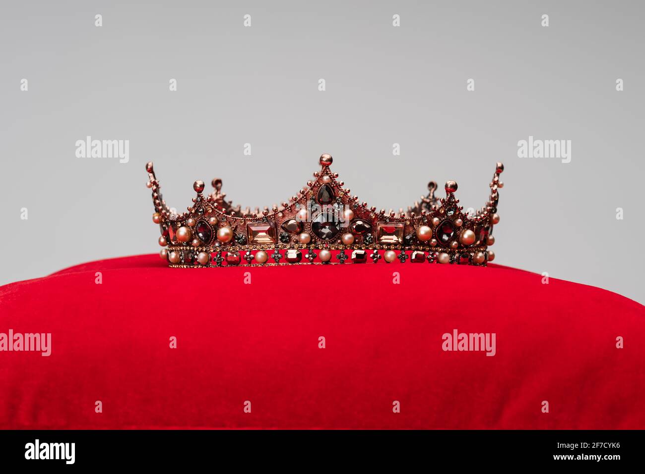 luxury crown on red velvet cushion isolated on grey Stock Photo - Alamy