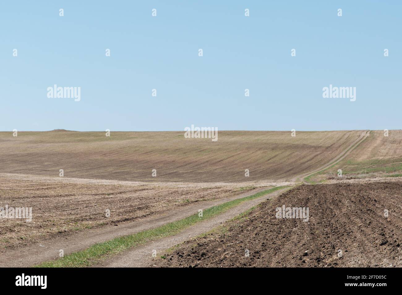 Agricultural plowed field. Ploughing field. Arable land under the ...