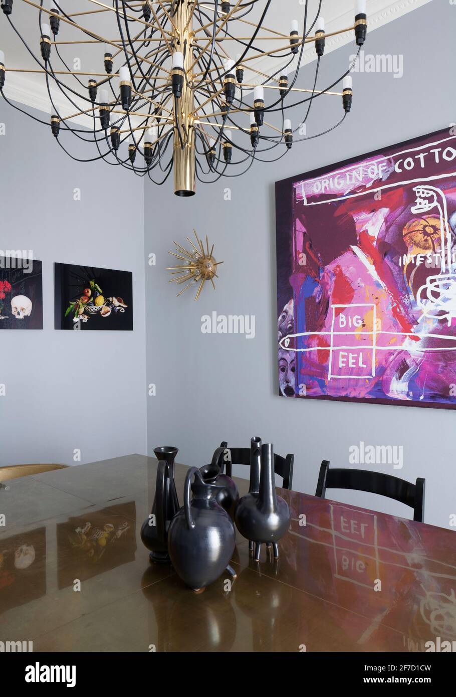 Elegant dining room in a private apartment with a Basquiat artwork on ...