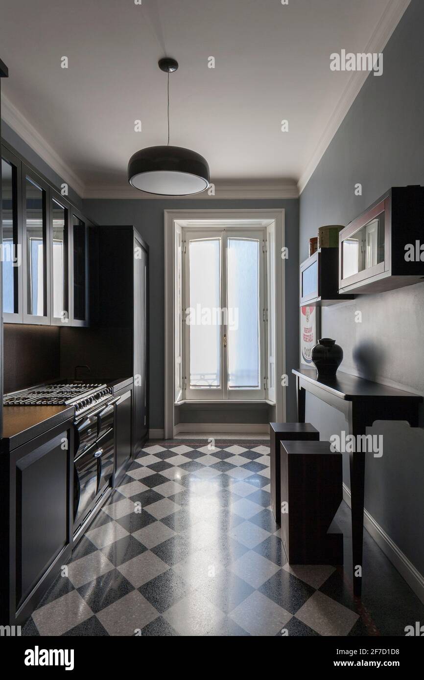 interior with a miniamlistic kitchen in a italian house in Florence ...