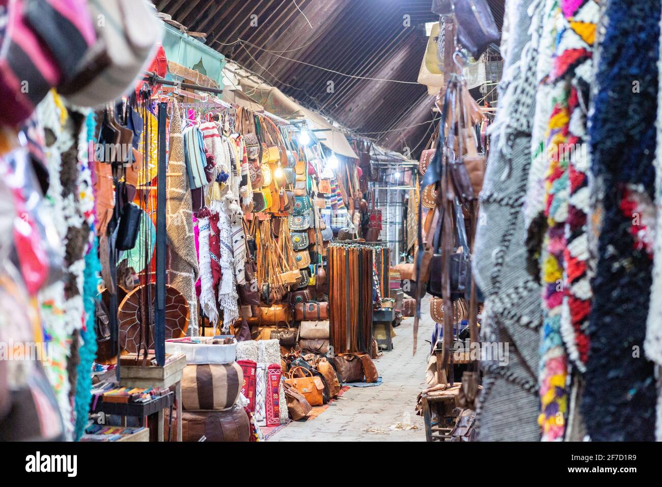 A market stand with clothing and leather goods in the souks of ...