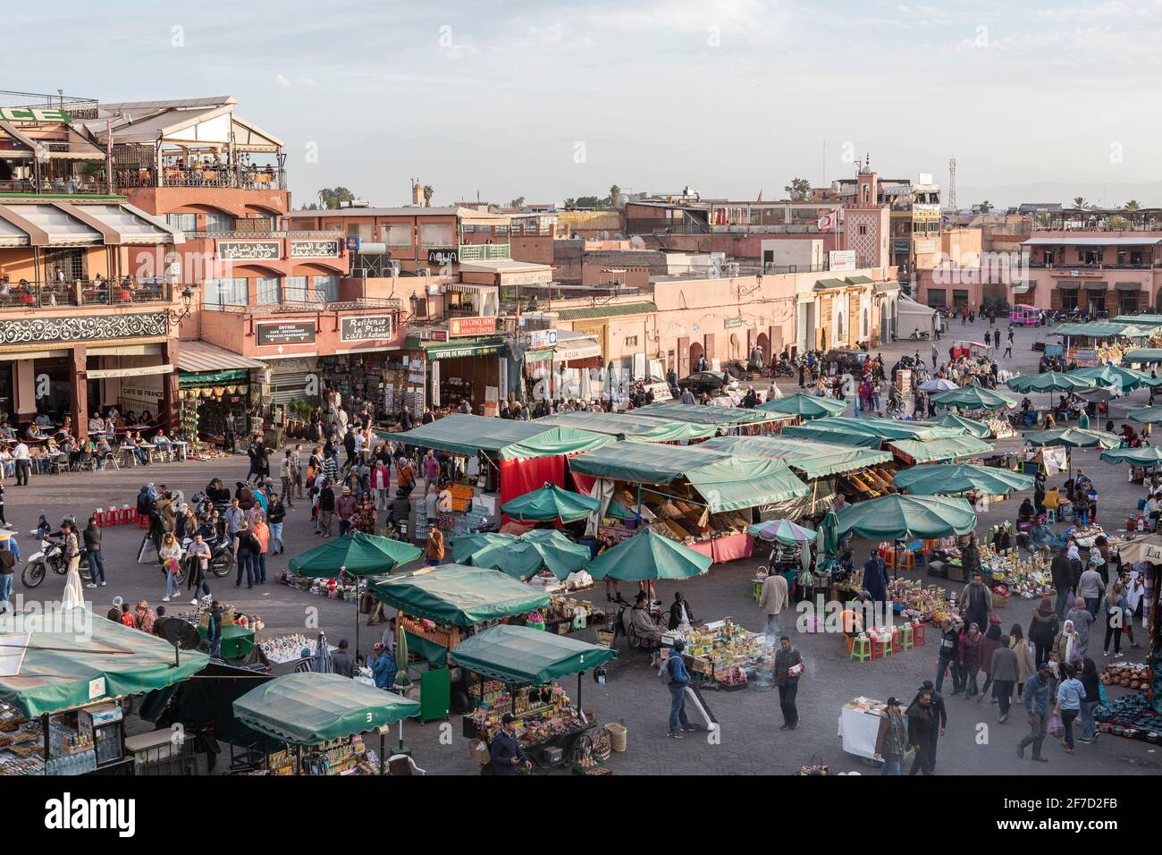 Hustle and bustle around the Market stands with their green roofs at ...