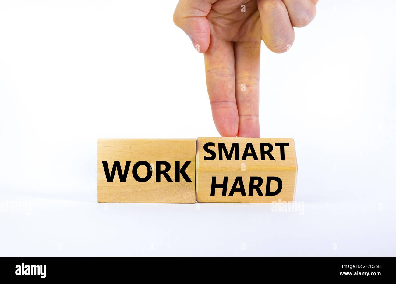 Work hard or smart symbol. Businessman turns wooden block and changes ...