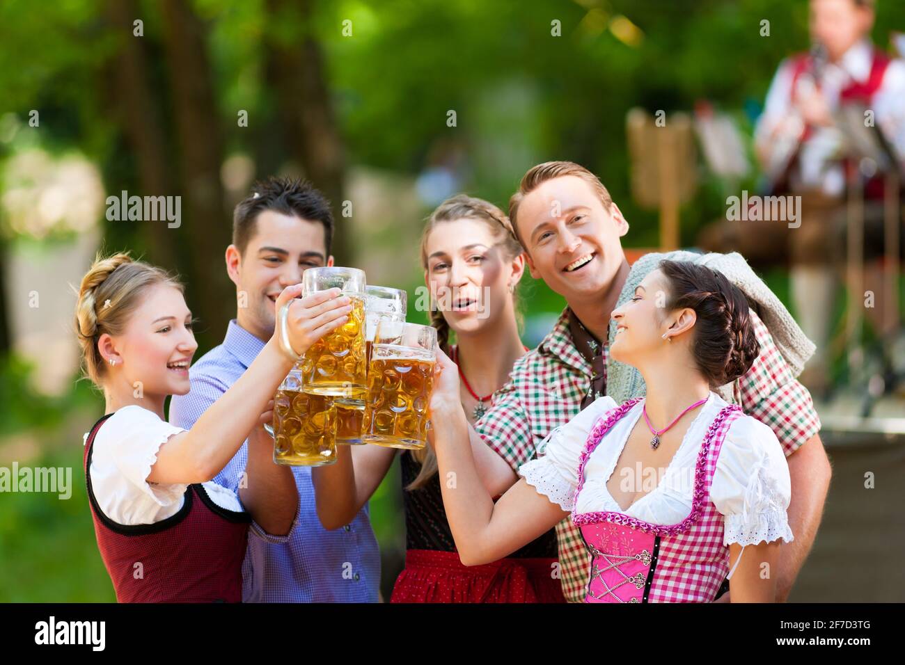 In Beer garden in Bavaria, Germany - friends in Tracht, Dirndl and ...