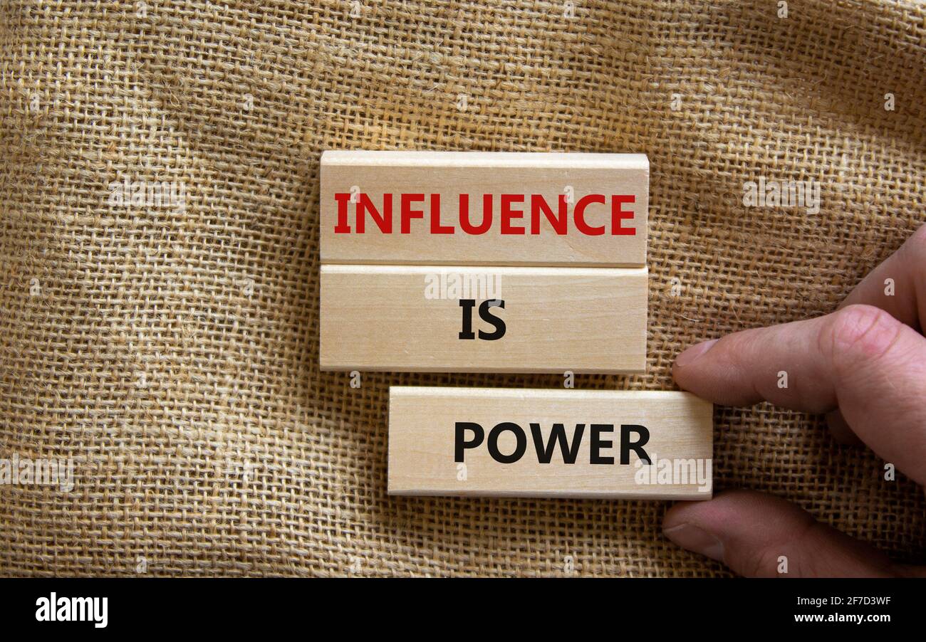Influence is power symbol. Wooden blocks with words 'Influence is power ...