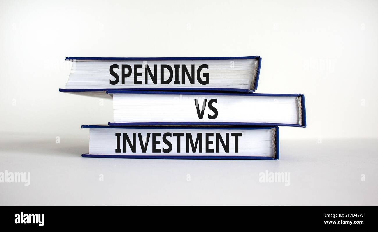 Spending vs investment strategy symbol. Books with words 'Spending vs ...