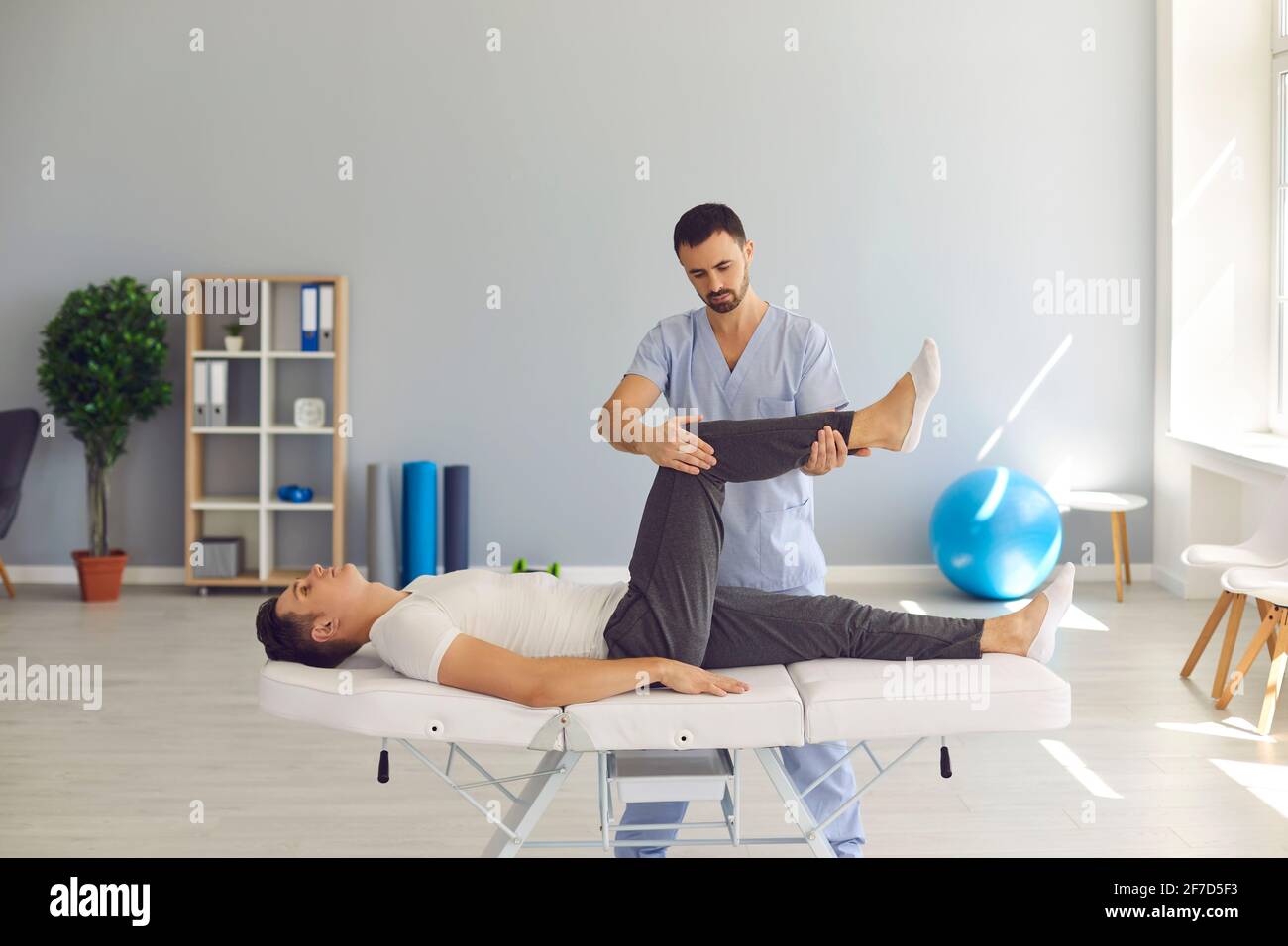 Doctor checking patients foot in hi-res stock photography and images ...