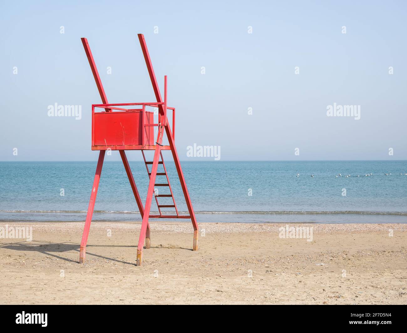 Red lifeguard chair on an empty beach Stock Photo - Alamy
