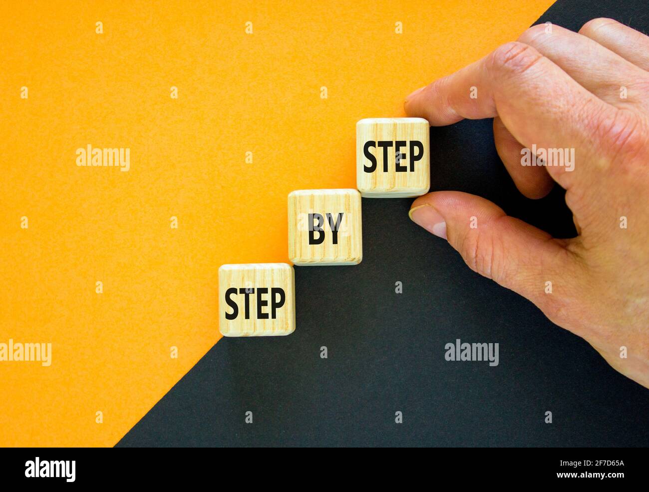 Step by step symbol. Hand arranging wood block stacking as step stair ...