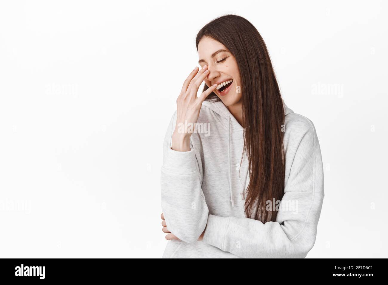 Candid girl laughing sincere, covering face while smiling and chuckle ...