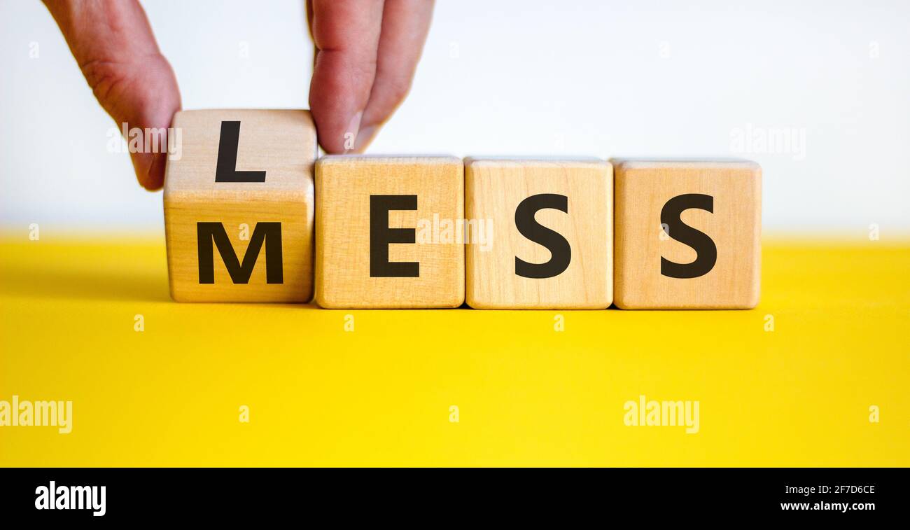 Less mess symbol. Businessman turns the cube and changes the word 'mess ...