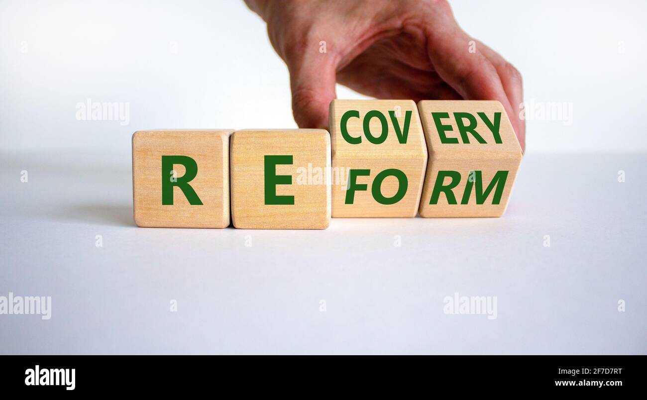Recovery and reform symbol. Businessman turns cubes and changes the ...