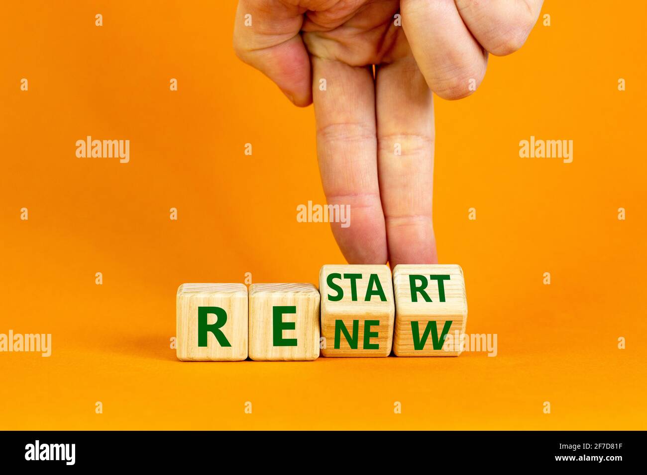 Renew and restart symbol. Businessman hand turns cubes and changes the ...