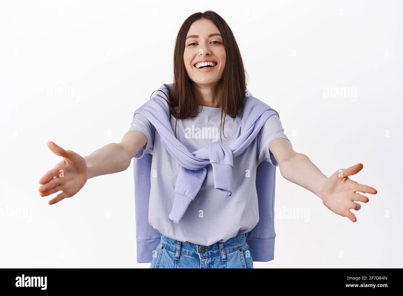 Come here. Smiling friendly woman stretching hands out for hug ...