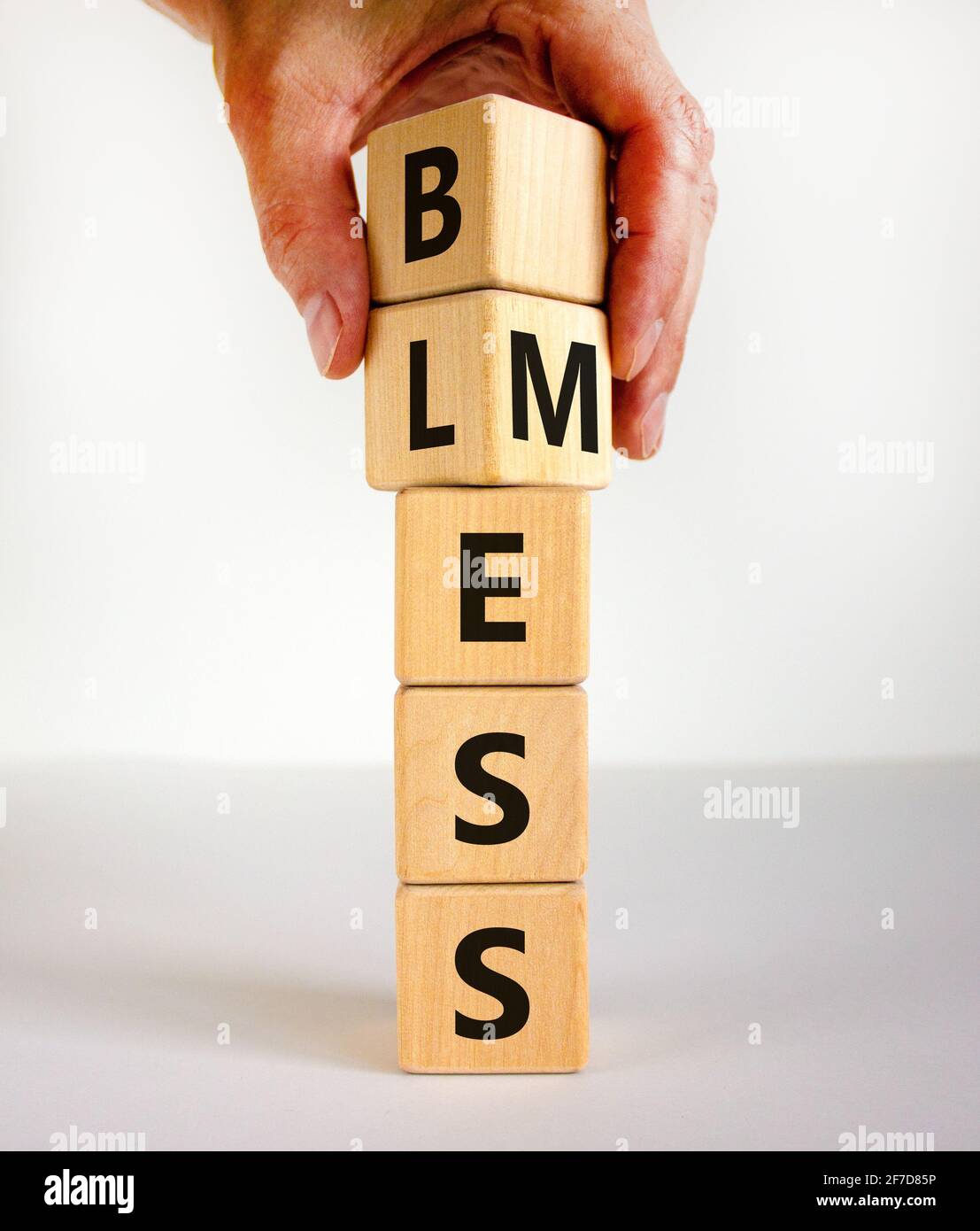 Bless mess symbol. Businessman turns the cube and changes the word ...