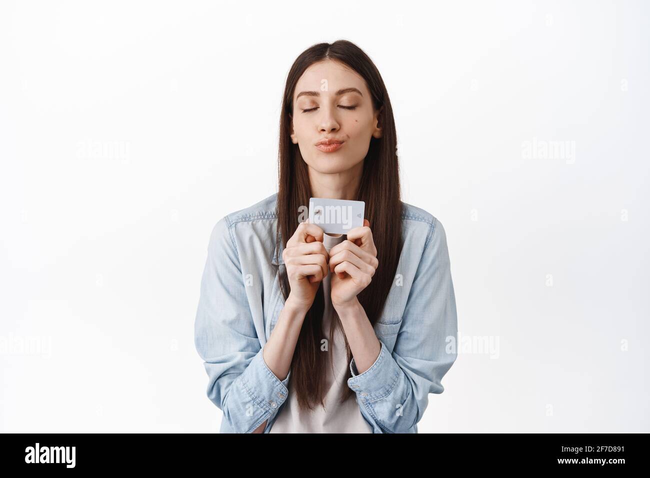 Silly romantic girl, waiting for shopping, kissing her credit card with ...