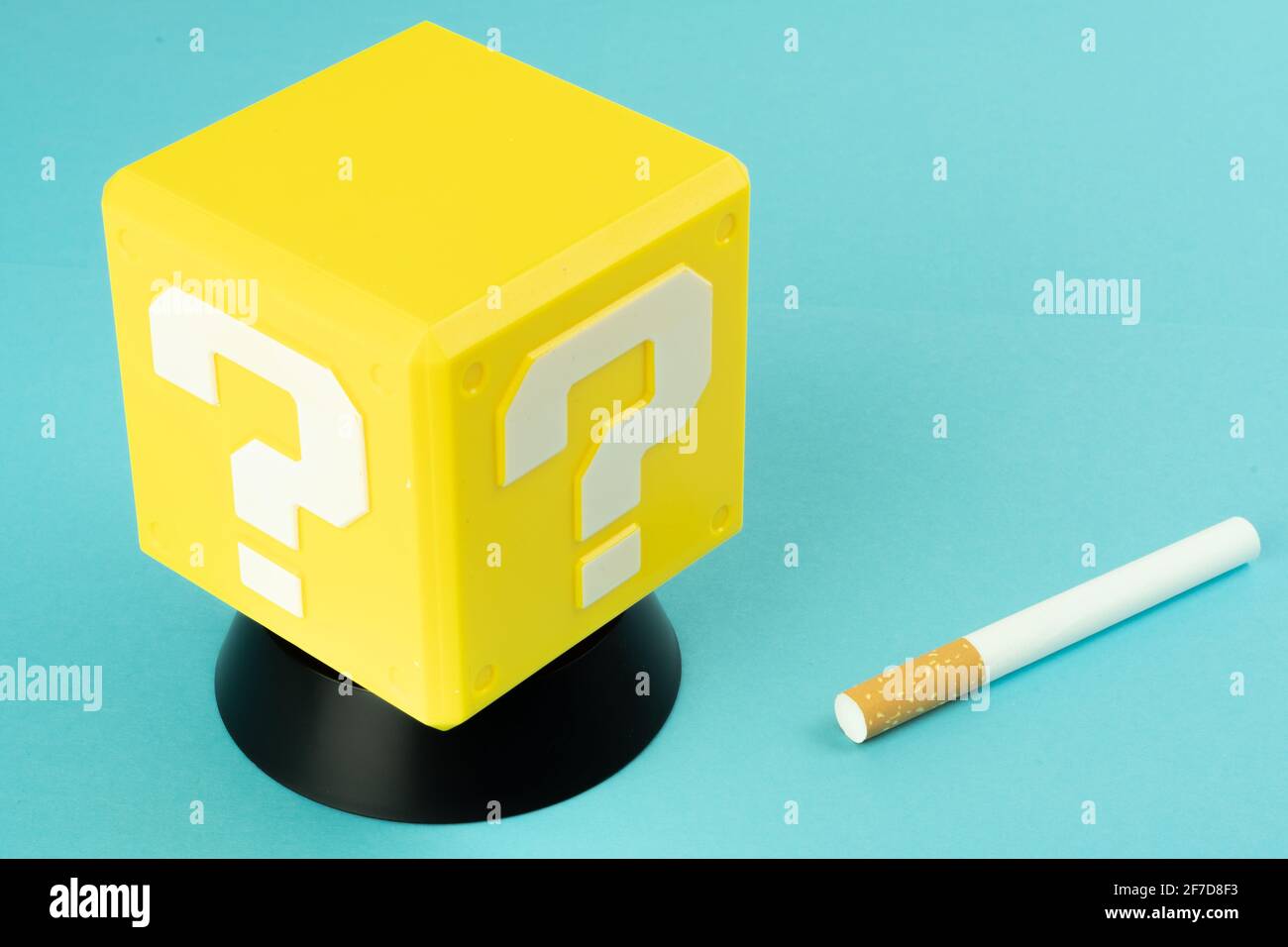 Question mark on blue background and cigarette and glass of whiskey ...