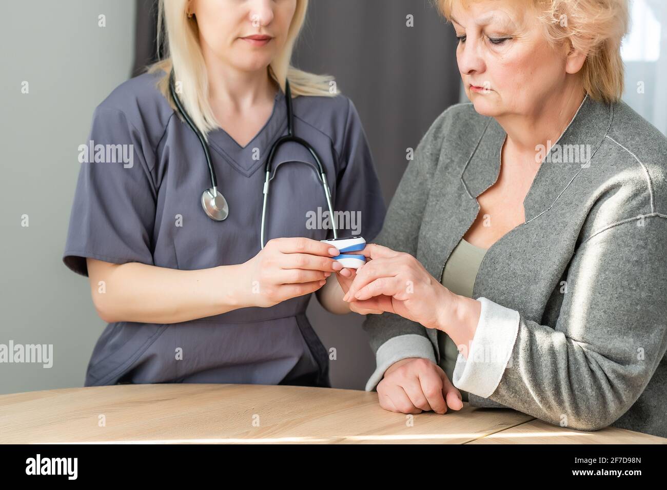 Doctor measuring patients hemoglobin level. Showing usage of finger ...