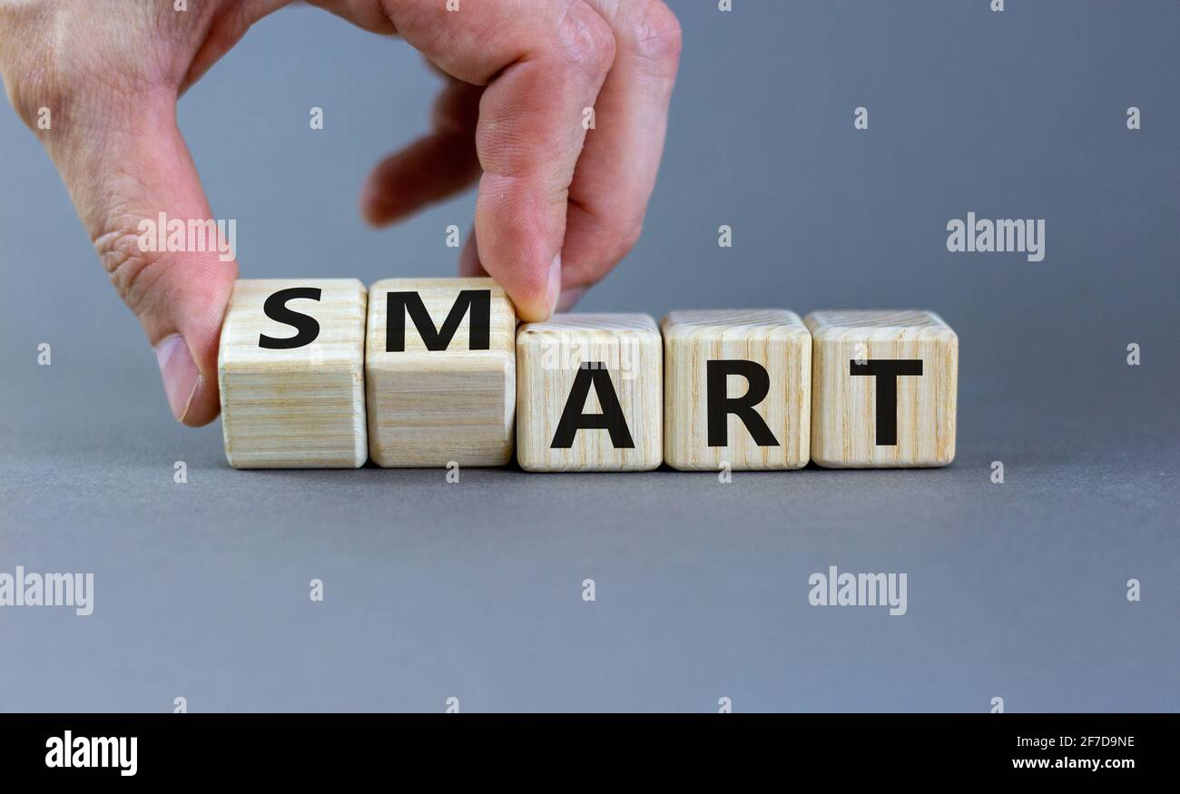 Smart art symbol. Businessman turns cubes and changes the word 'smart ...