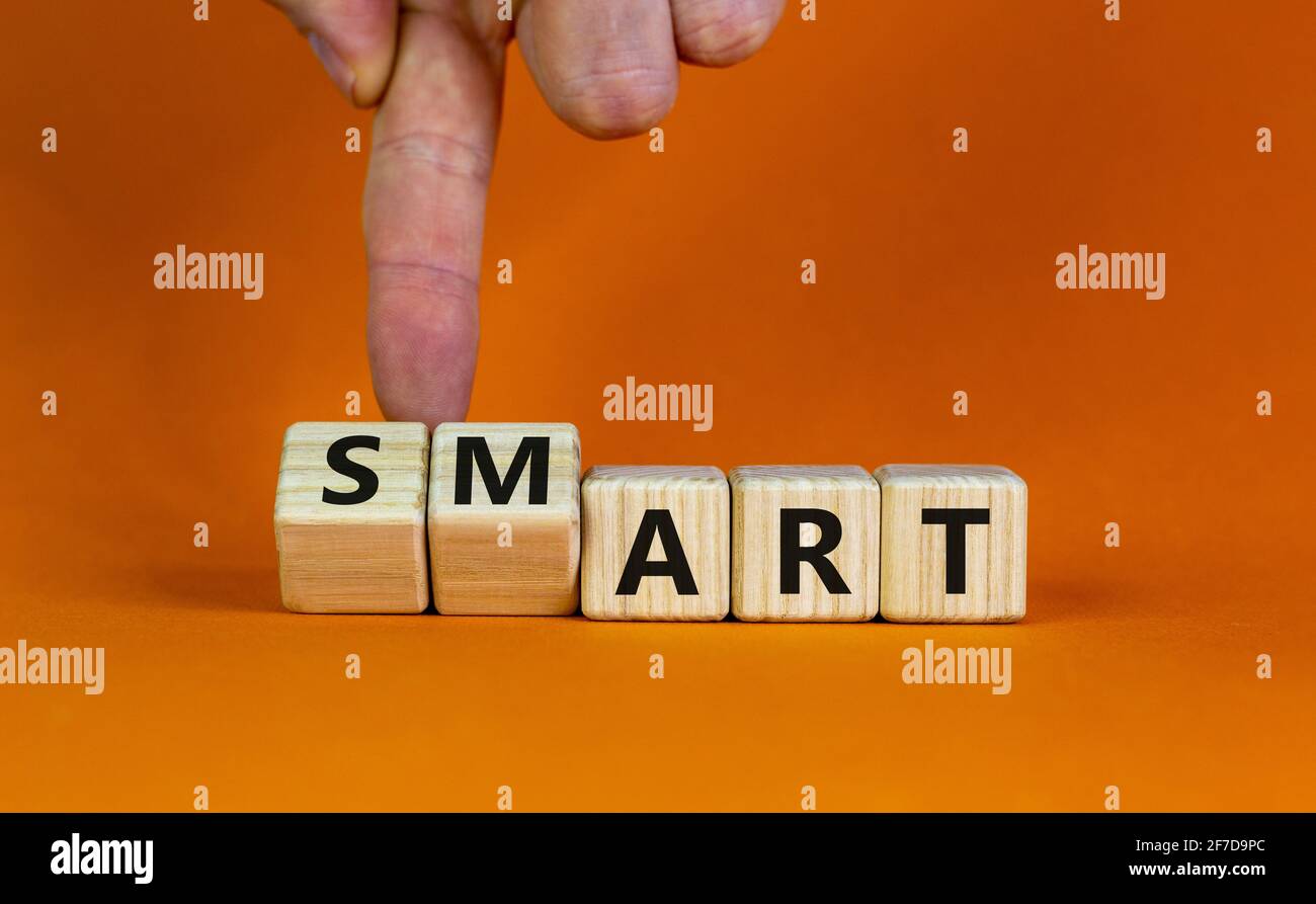 Smart art symbol. Businessman turns cubes and changes the word 'smart ...