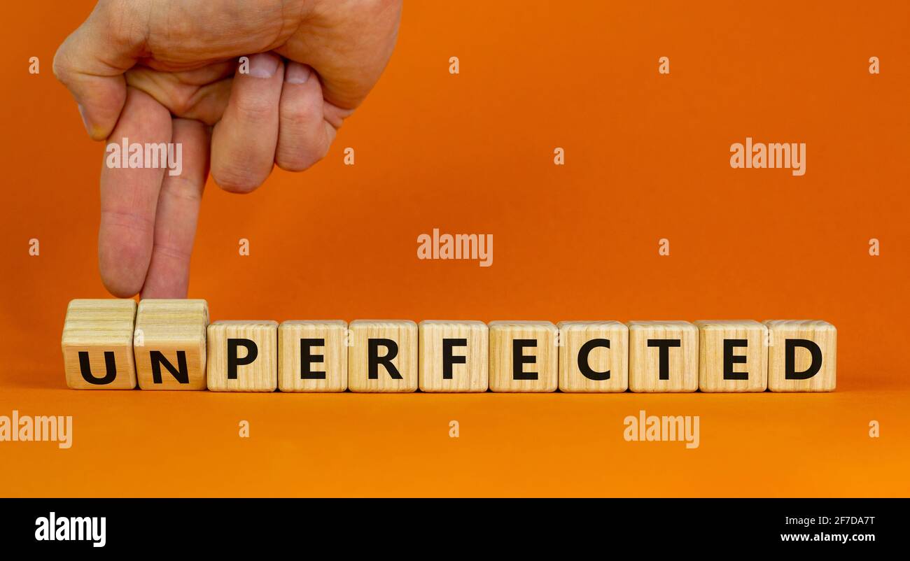 Perfected or unperfected symbol. Businessman turns wooden cubes and ...