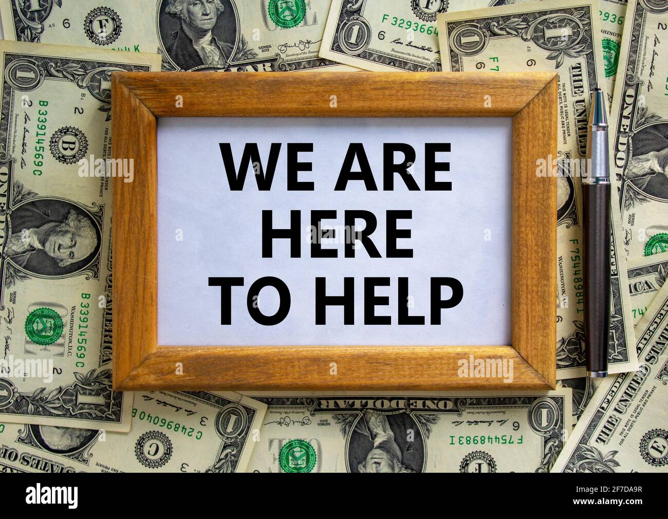 Support symbol. Wooden frame with words 'we are here to help' on ...