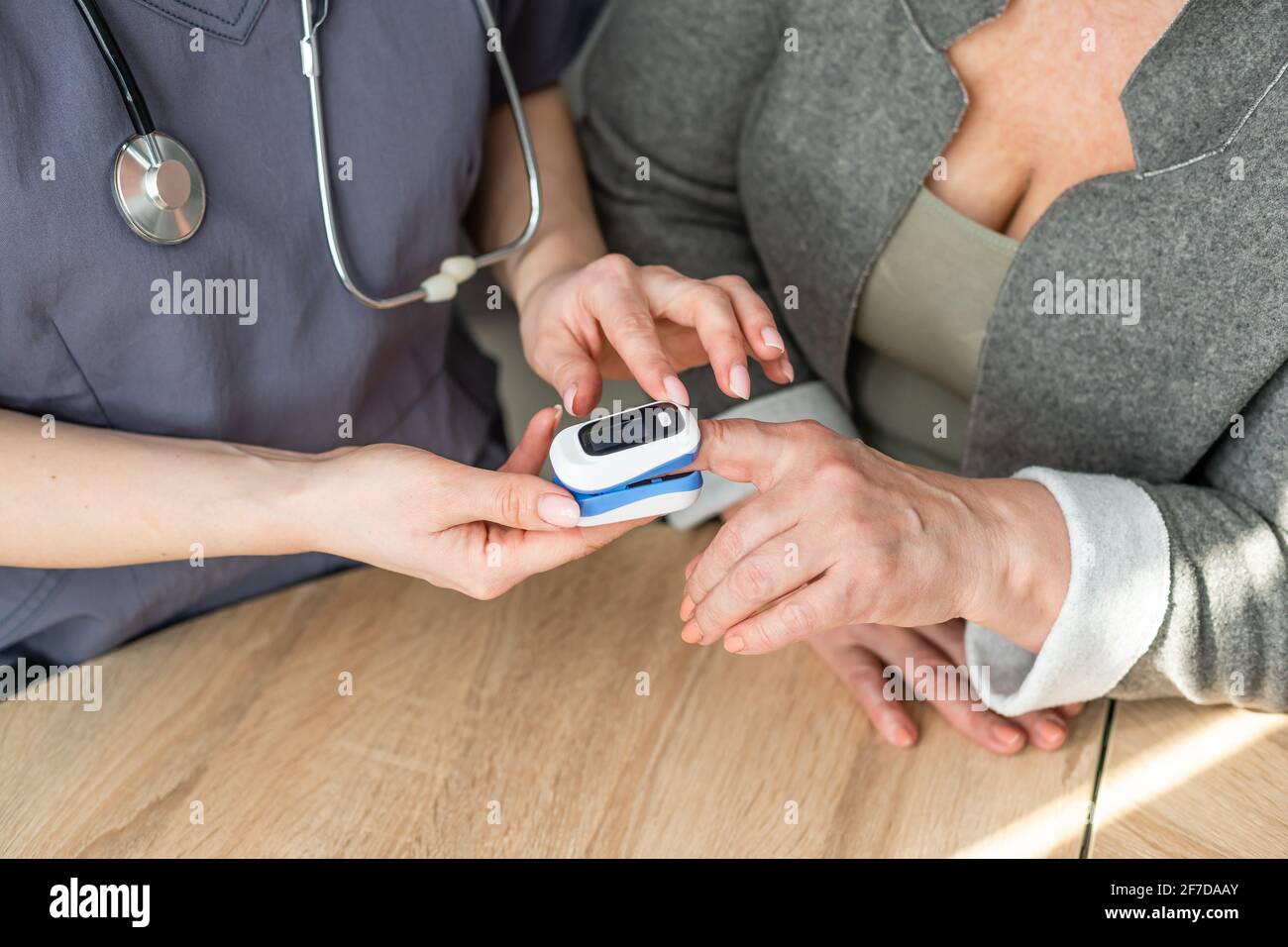 Doctor measuring patients hemoglobin level. Showing usage of finger ...