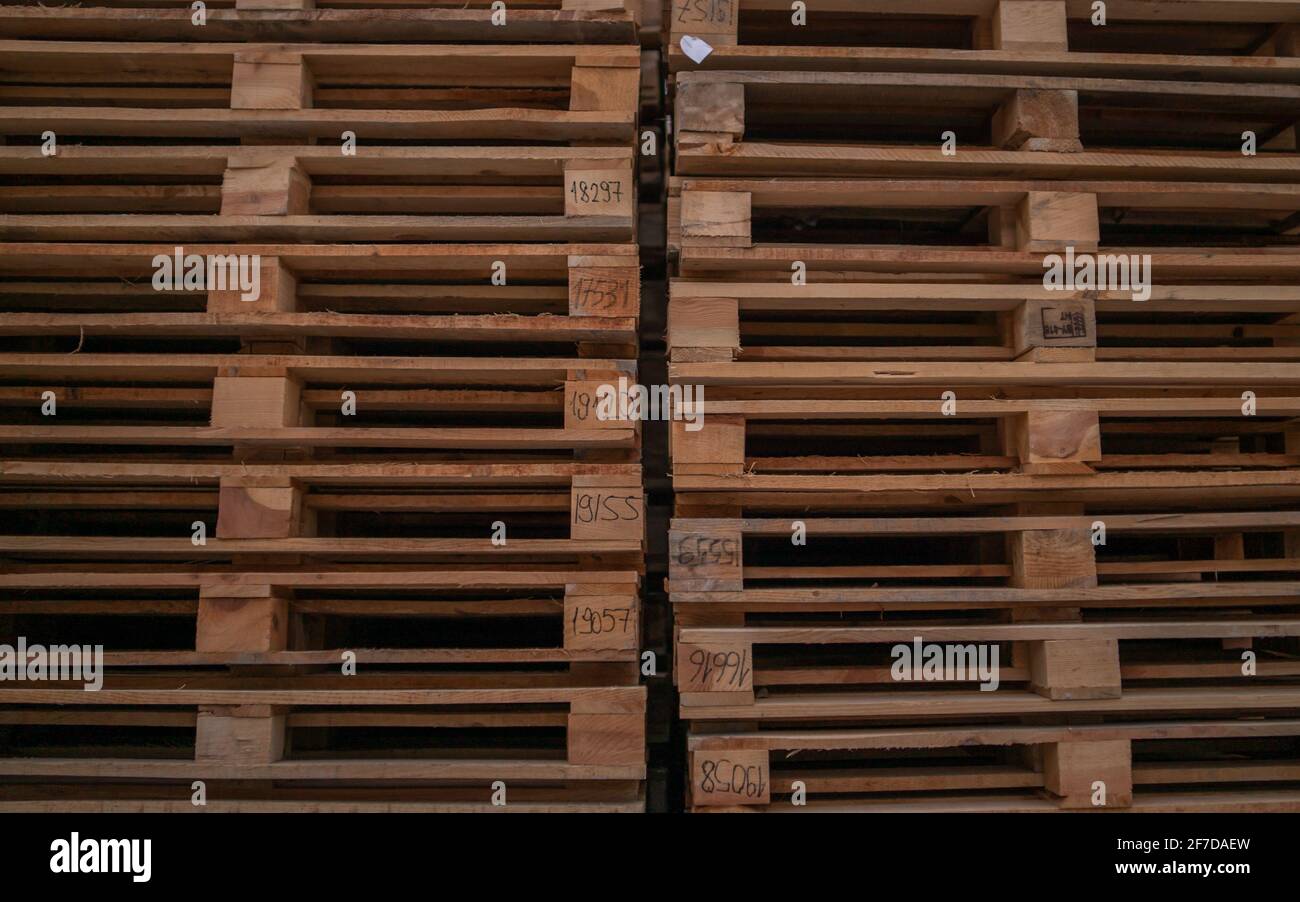 Wooden pallets for industrial and transport stacked in a large column ...