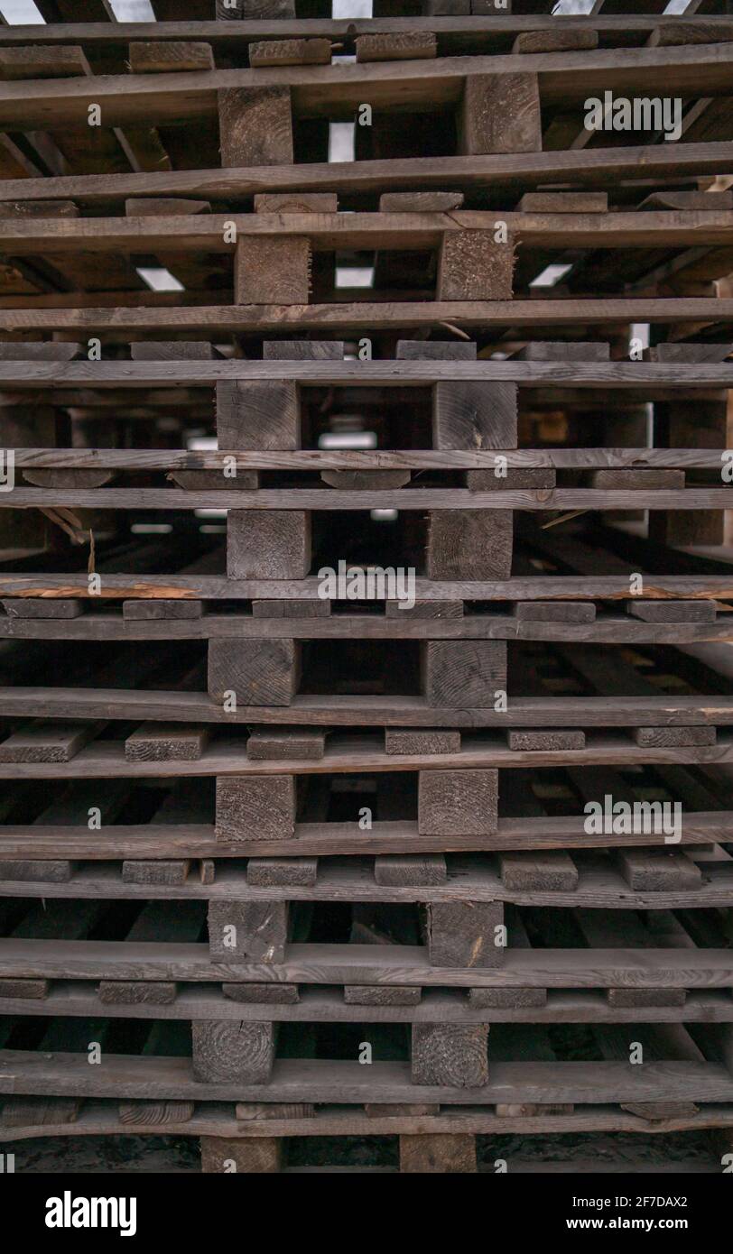 Wooden pallets for industrial and transport stacked in a large column ...