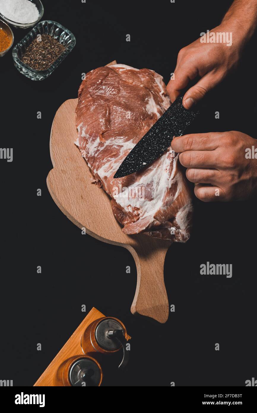 The cook cuts the fat on the neck, prepares the meat for marinating and ...
