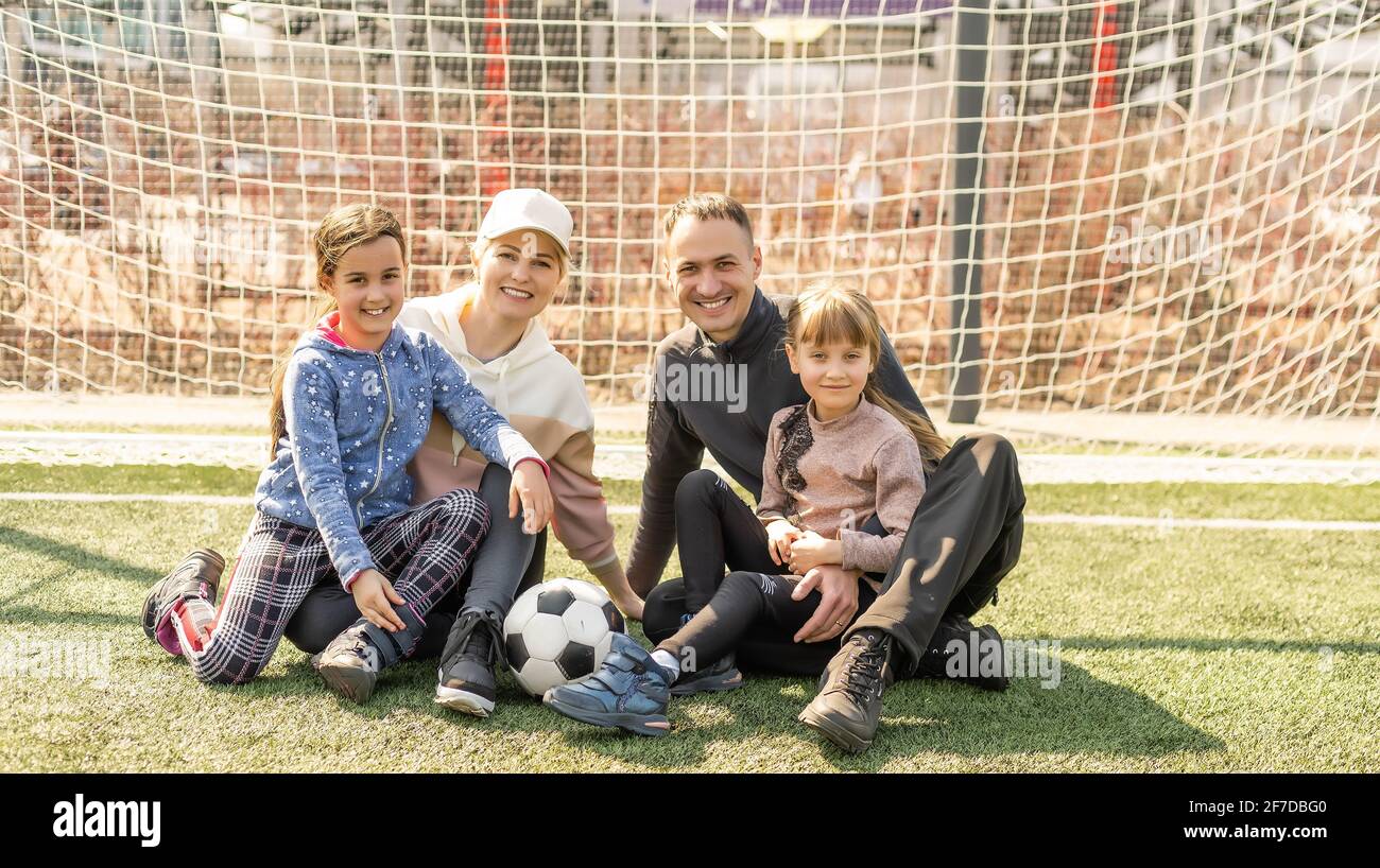 family with soccer ball in stadium Stock Photo - Alamy