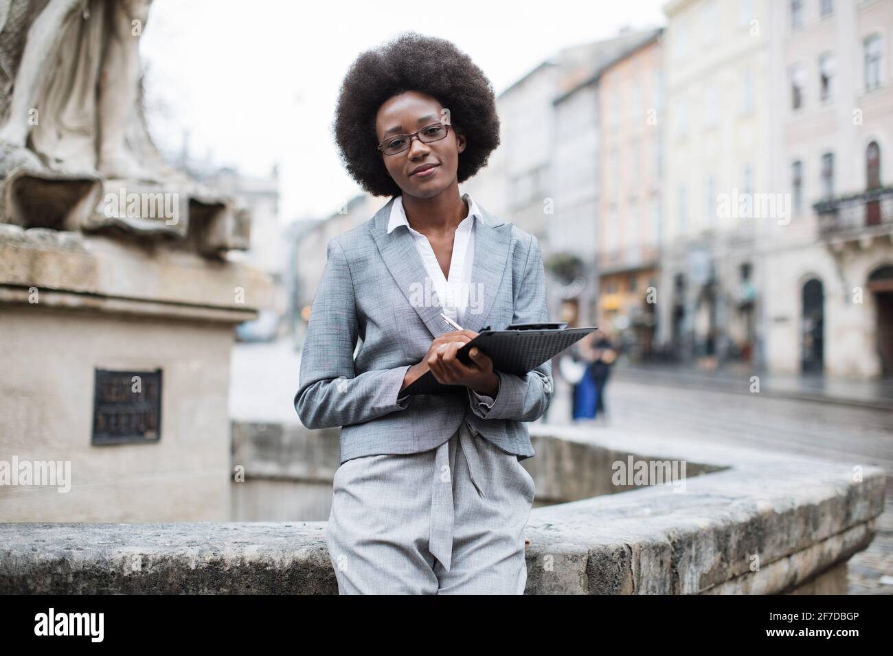 Front view of smiling african business woman in stylish formal clothes ...