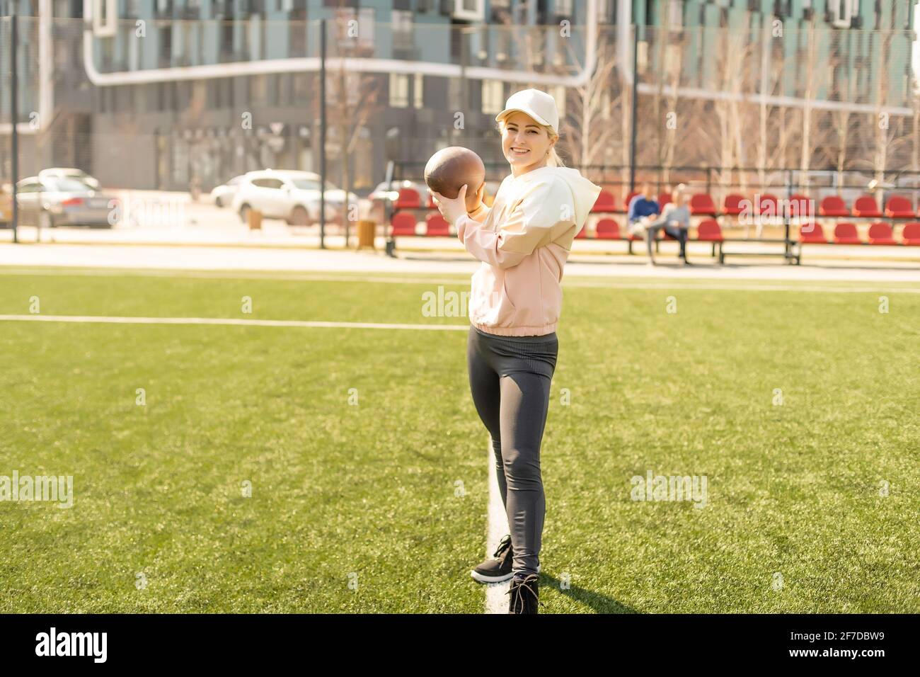 Pretty women's soccer. Young woman in sportswear with a soccer ball on ...