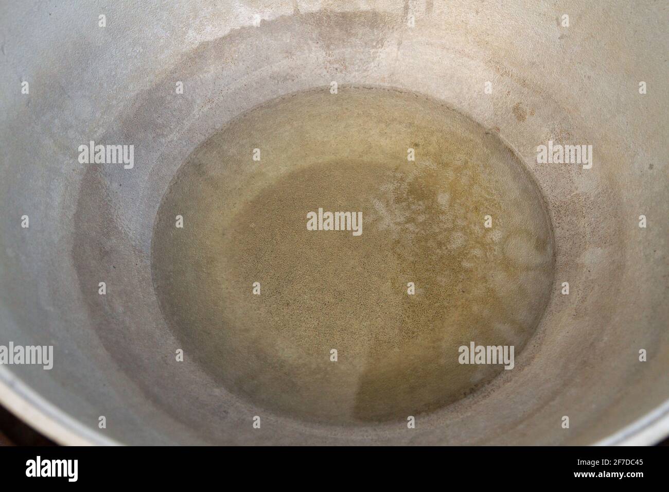Before cooking on coals, boil the oil in a cauldron Stock Photo - Alamy