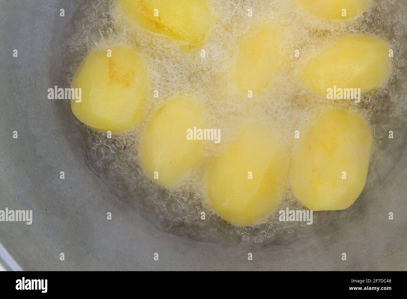 Golden potatoes are fried in boiling oil in a cauldron Stock Photo - Alamy