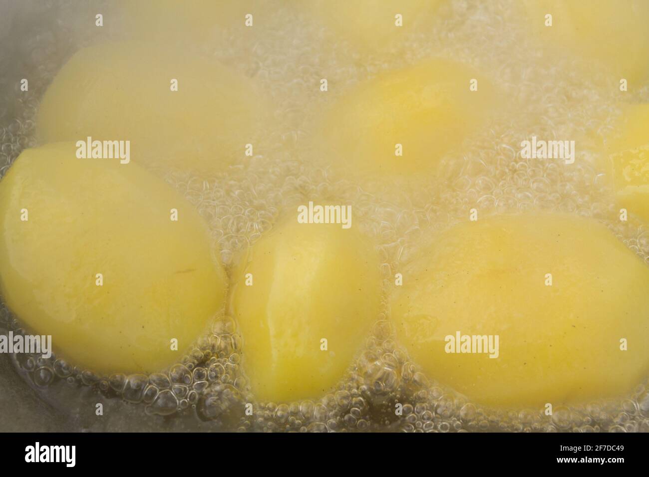 Golden potatoes are fried in boiling oil in a cauldron Stock Photo - Alamy