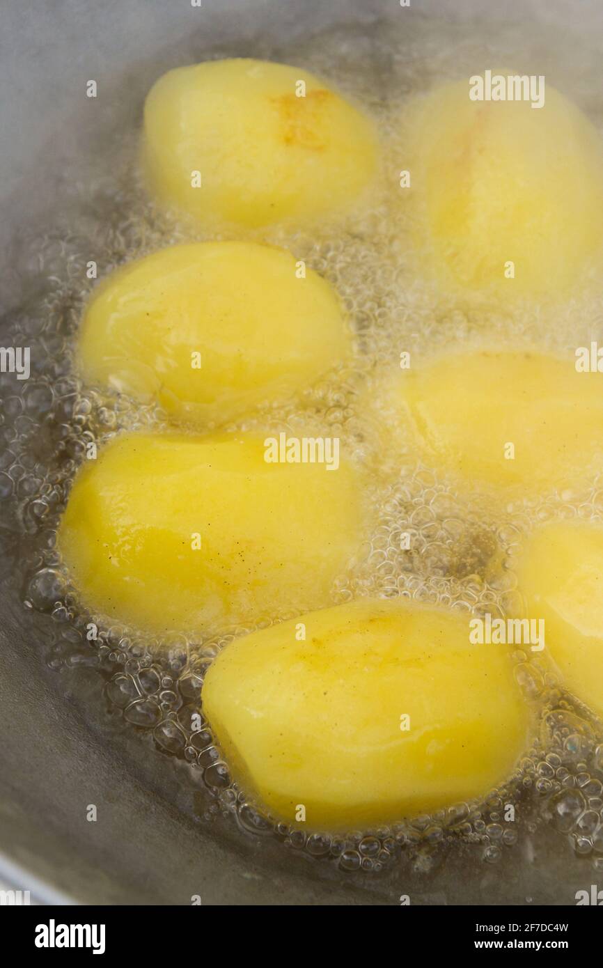 Golden potatoes are fried in boiling oil in a cauldron Stock Photo - Alamy