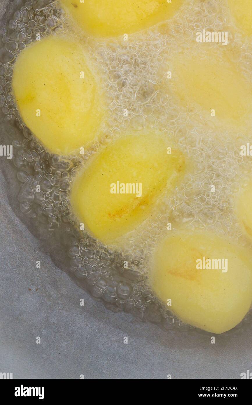 Golden potatoes are fried in boiling oil in a cauldron Stock Photo - Alamy