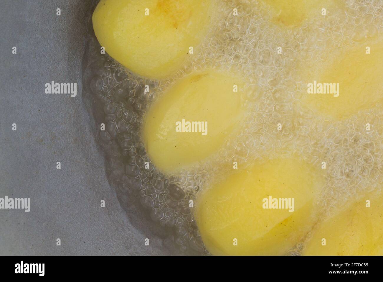 Golden potatoes are fried in boiling oil in a cauldron Stock Photo - Alamy