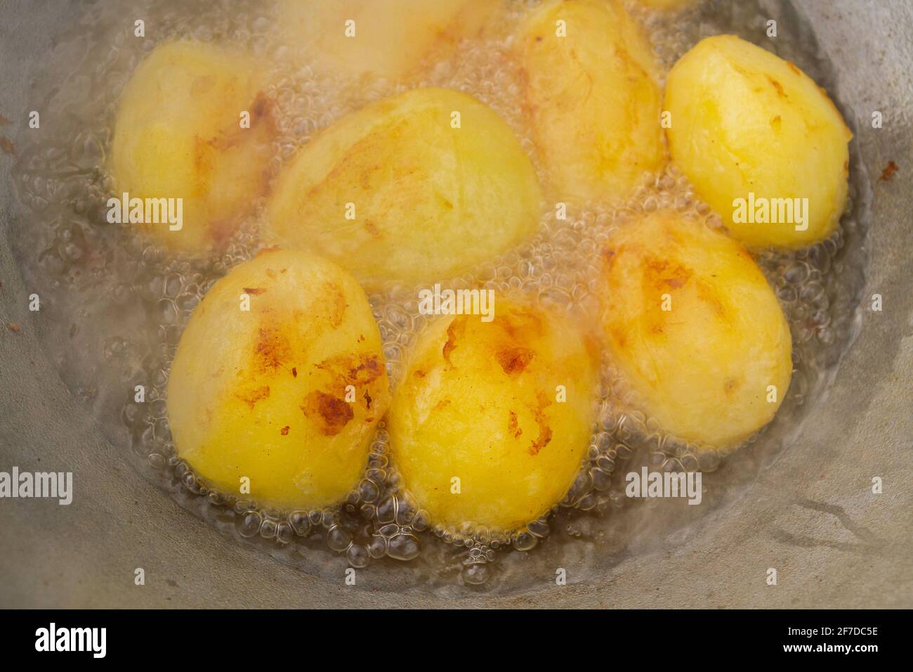 Golden potatoes are fried in boiling oil in a cauldron Stock Photo - Alamy