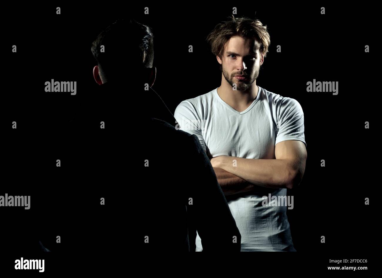 Two men standing opposite. Focused man, serious guy having conversation ...