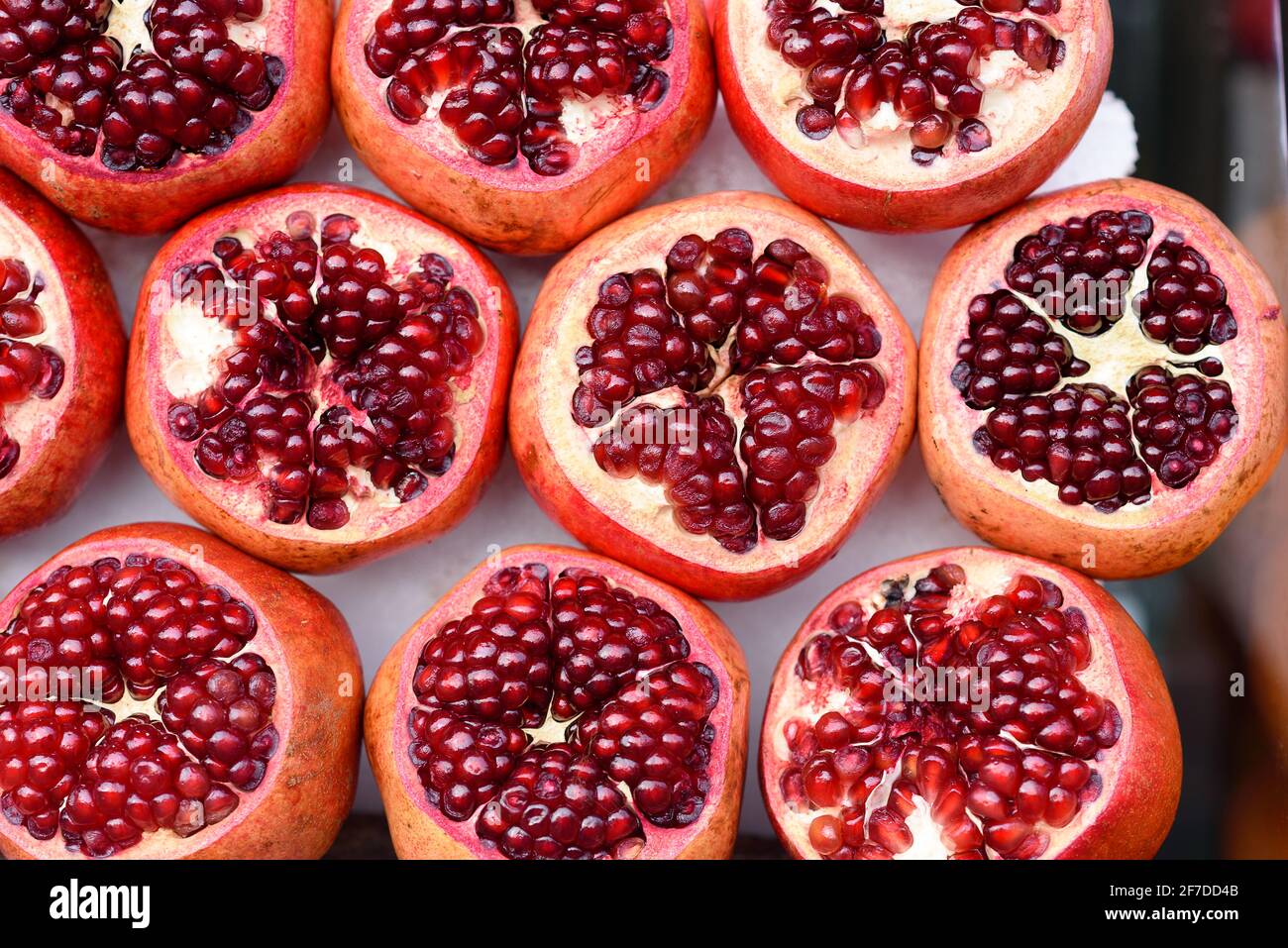 Juicy pomegranates with seed and half fleshy orange background Stock ...