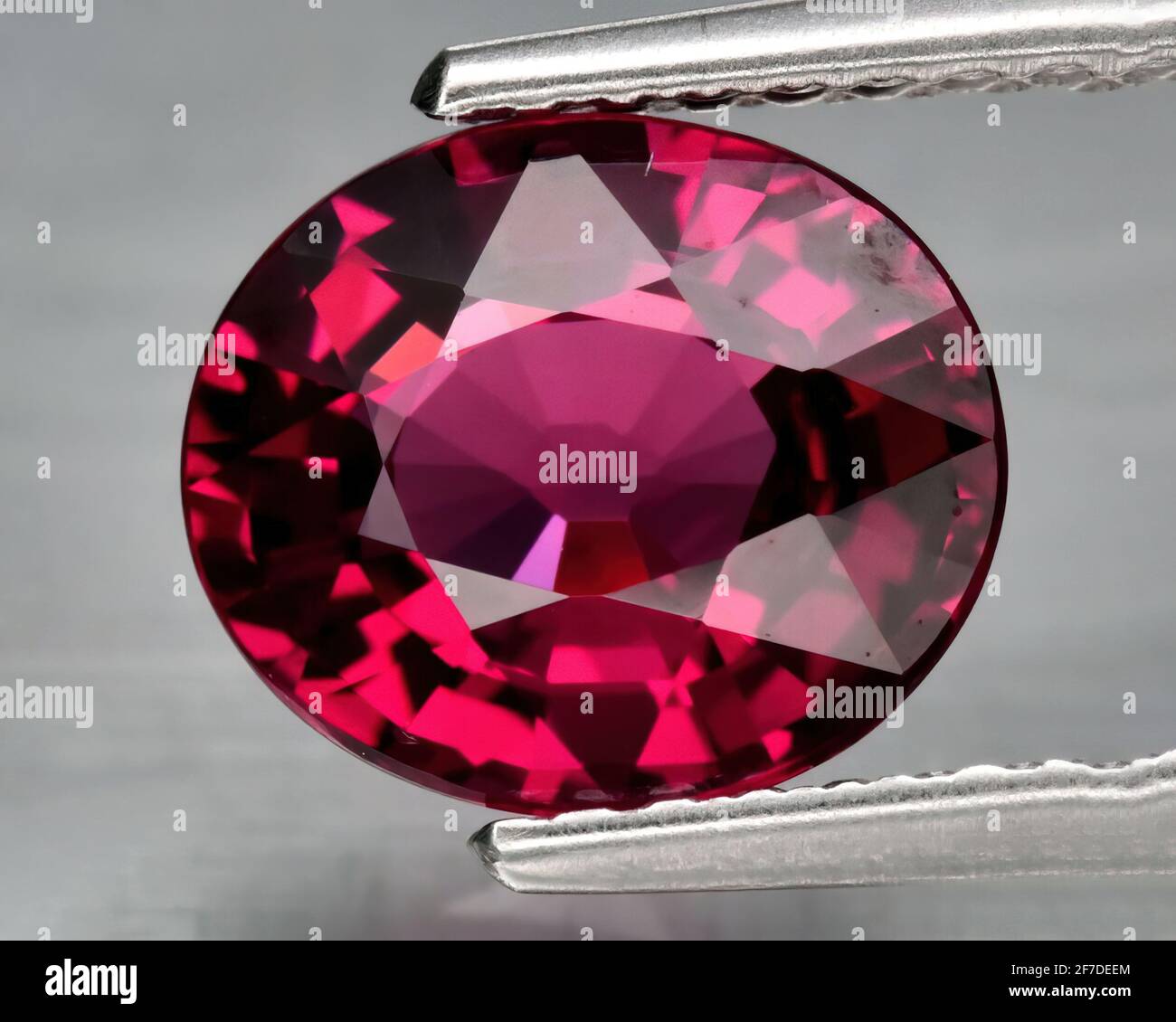 Natural gemstone rhodolite garnet on gray background Stock Photo - Alamy