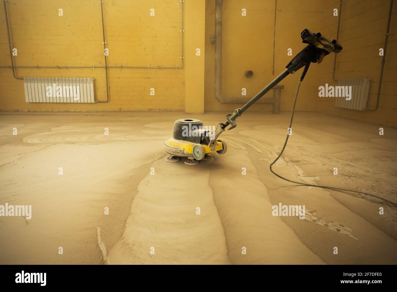 Concrete floor grinding. Construction process. Sanding a concrete floor ...