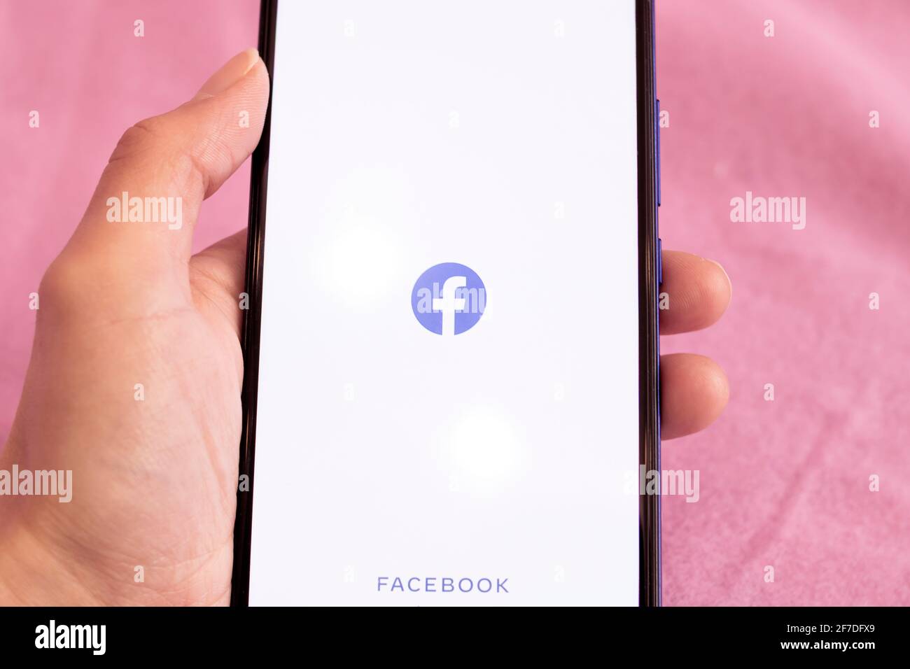 NOVOPOLOTSK, BELARUS - 06 FEBRUARY, 2021: Phone in hand and facebook ...