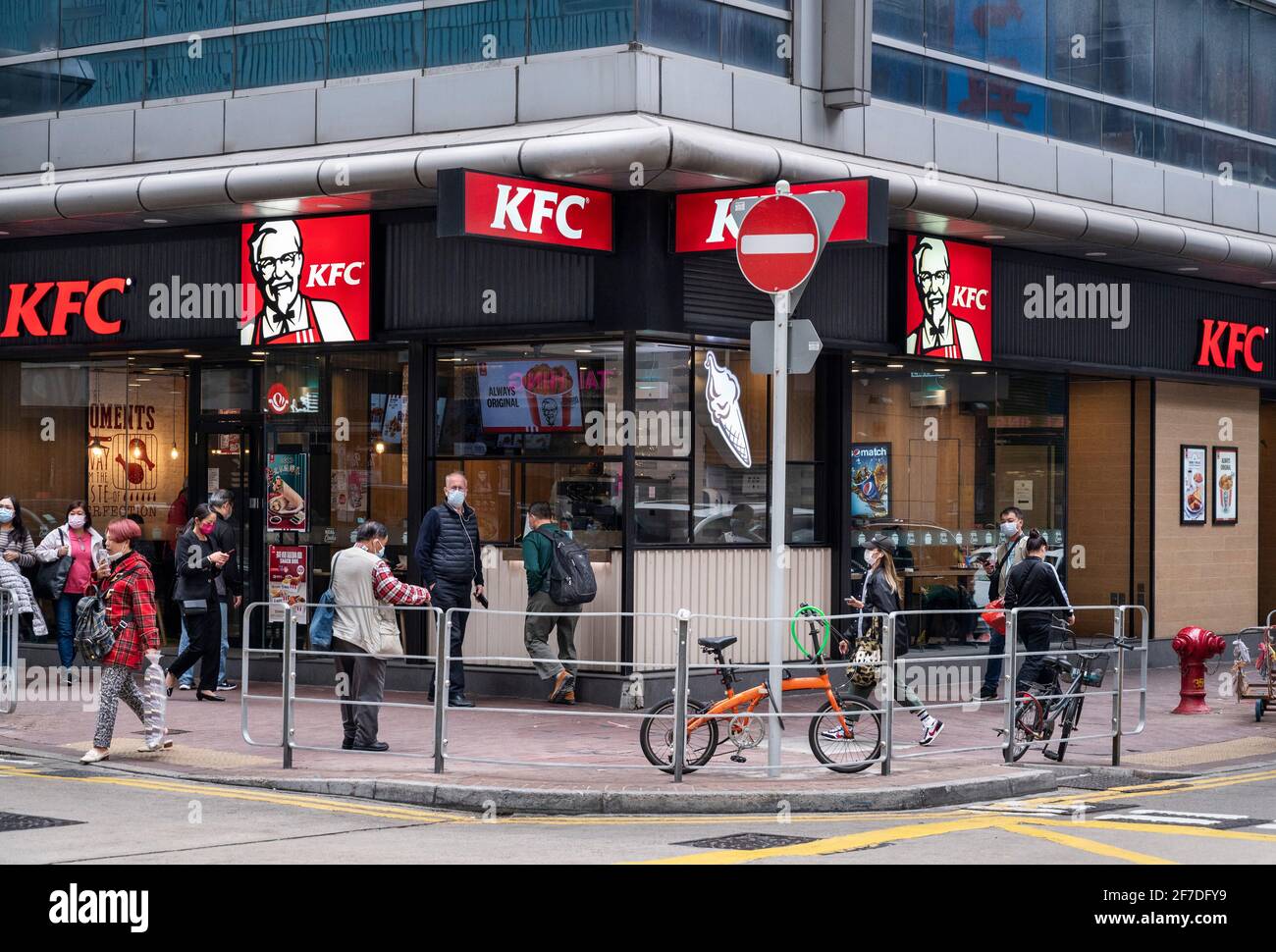 Pedestrians walk past an American fast food chicken restaurant chain ...