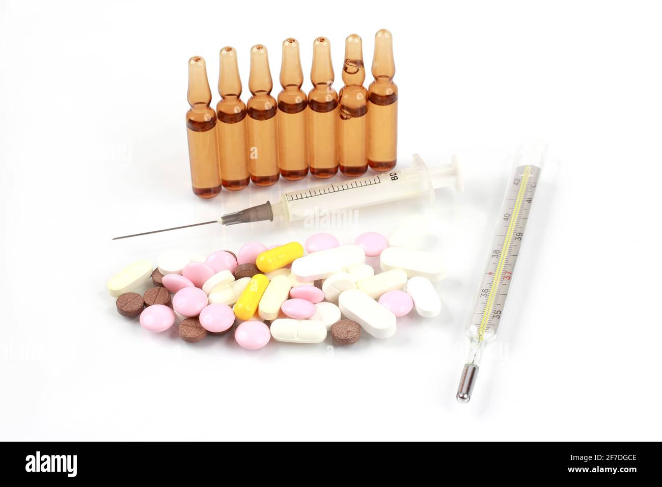 medicinal tablets, ampules for injections, thermometer, syringe on ...